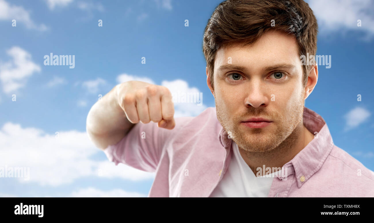 angry young man ready for fist punch over sky Stock Photo - Alamy