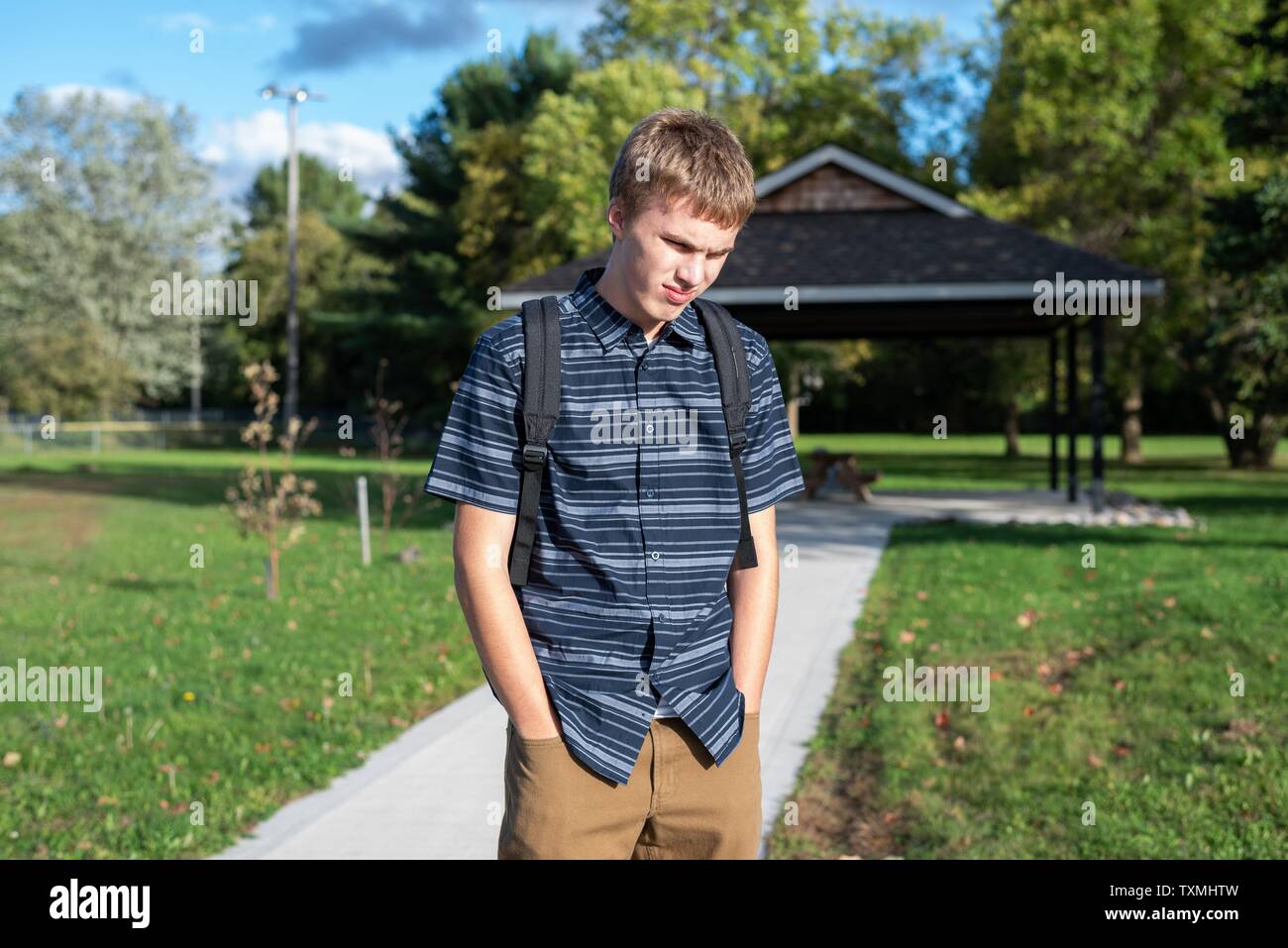 Angry student standing on a walkway that leads to a little pavilion ...