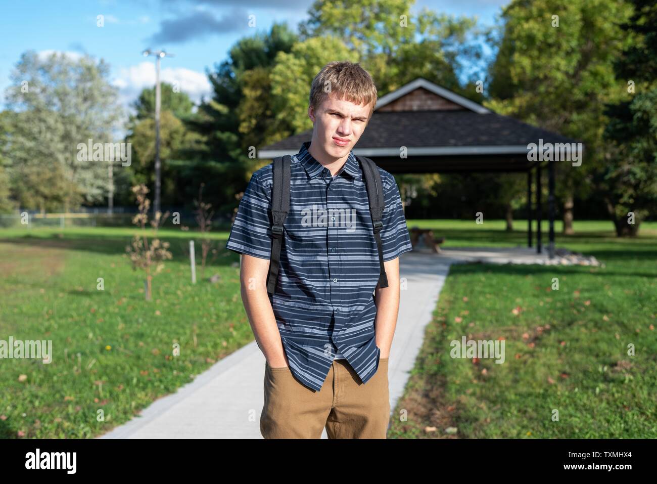 Angry student standing on a walkway that leads to a little pavilion ...