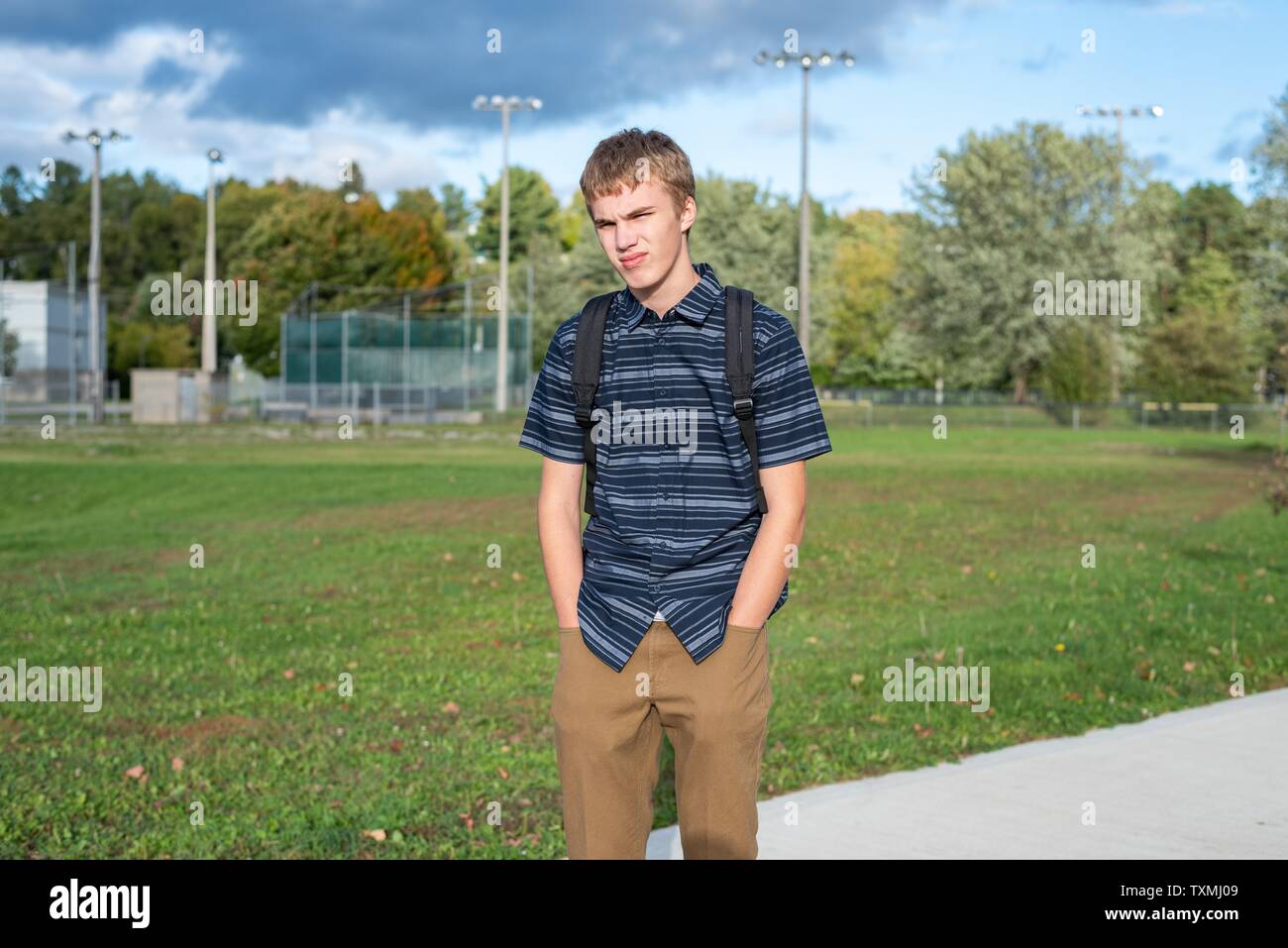 Angry student standing on a walkway that leads to a little pavilion ...