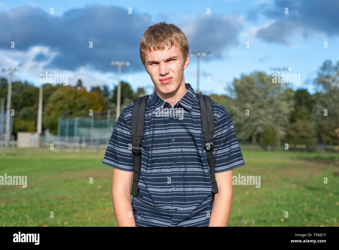 Angry student standing on a walkway that leads to a little pavilion ...