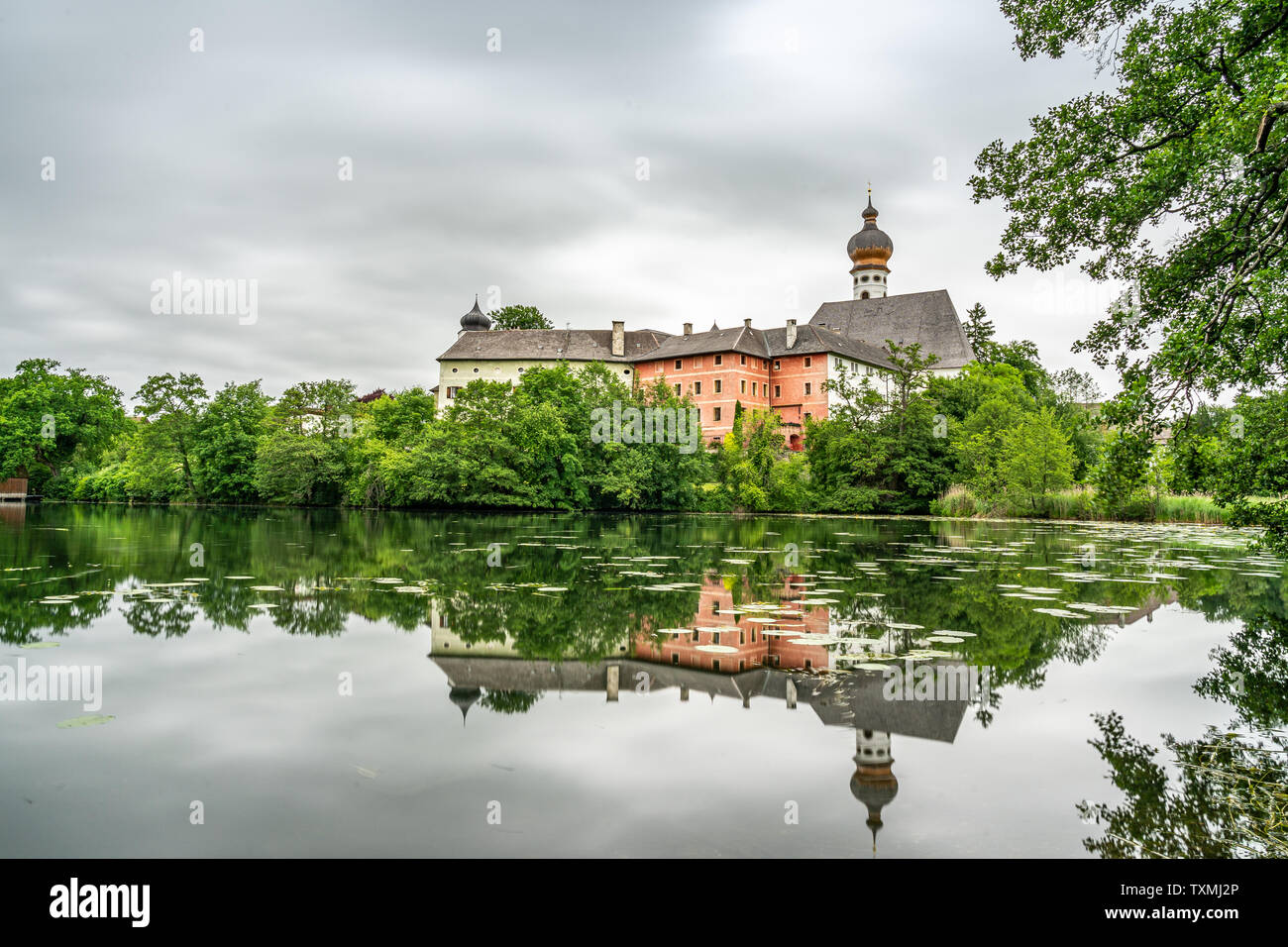 hoeglwoerth abbey and its reflection in the lake near anger in bavaria ...