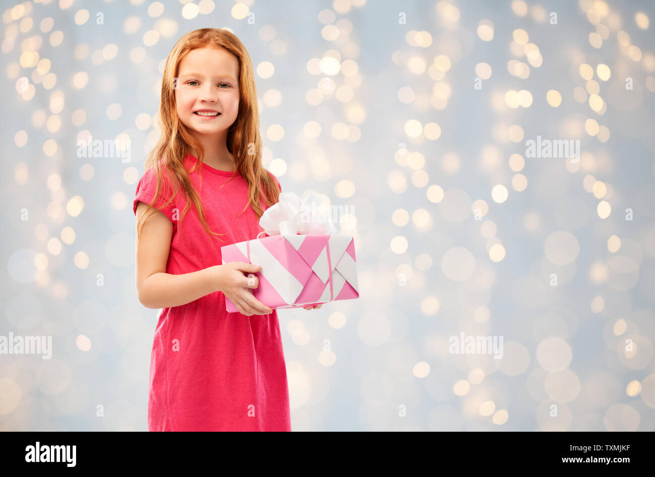 smiling red haired girl with birthday gift Stock Photo - Alamy