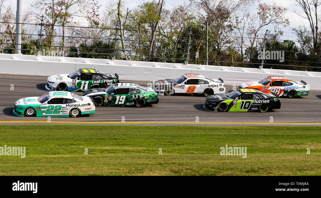 Austin Cindric (22) drives below a large pack of cars into turn 3 ...