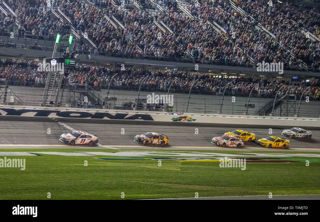 Denny Hamlin (18) crosses the finish line ahead of Kyle Busch to win ...