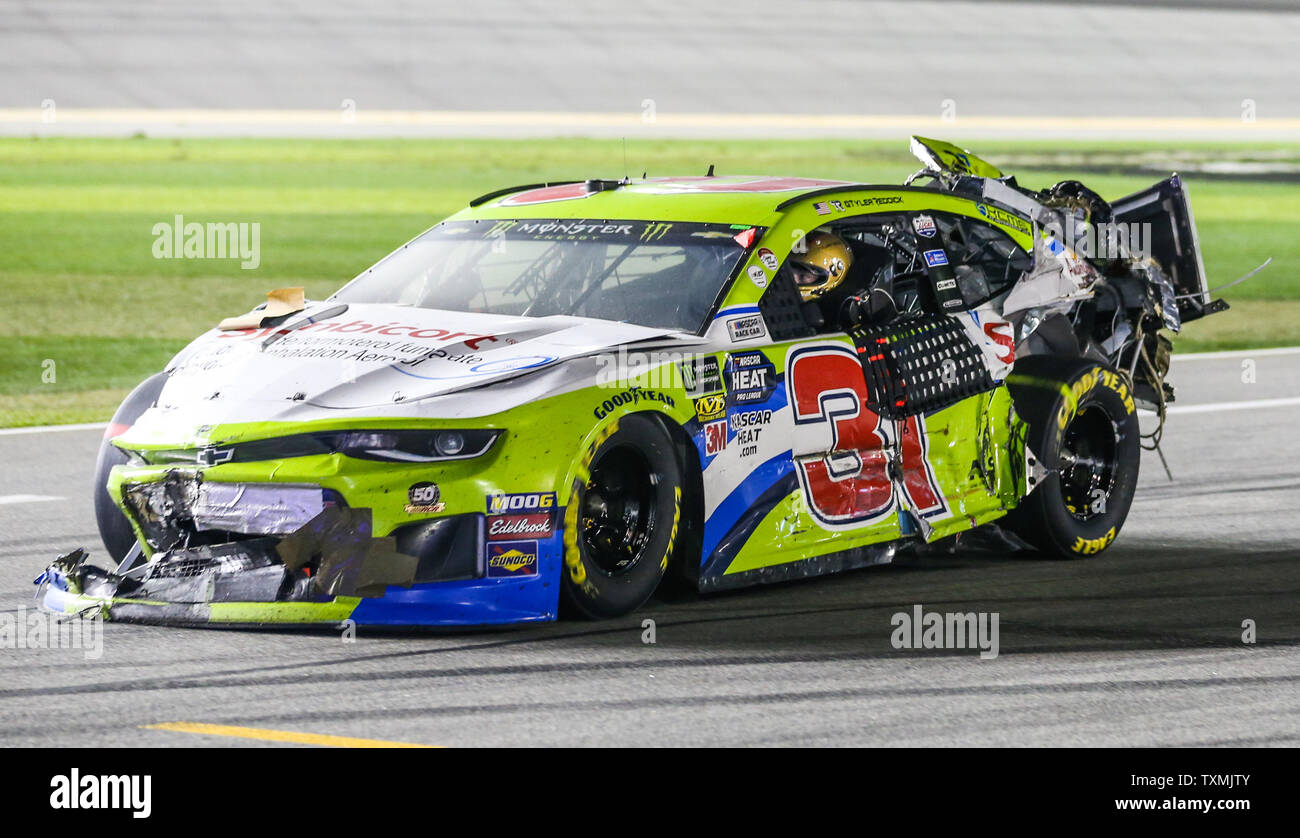 Tyler Reddick drives his crippled race car back through pit road after ...