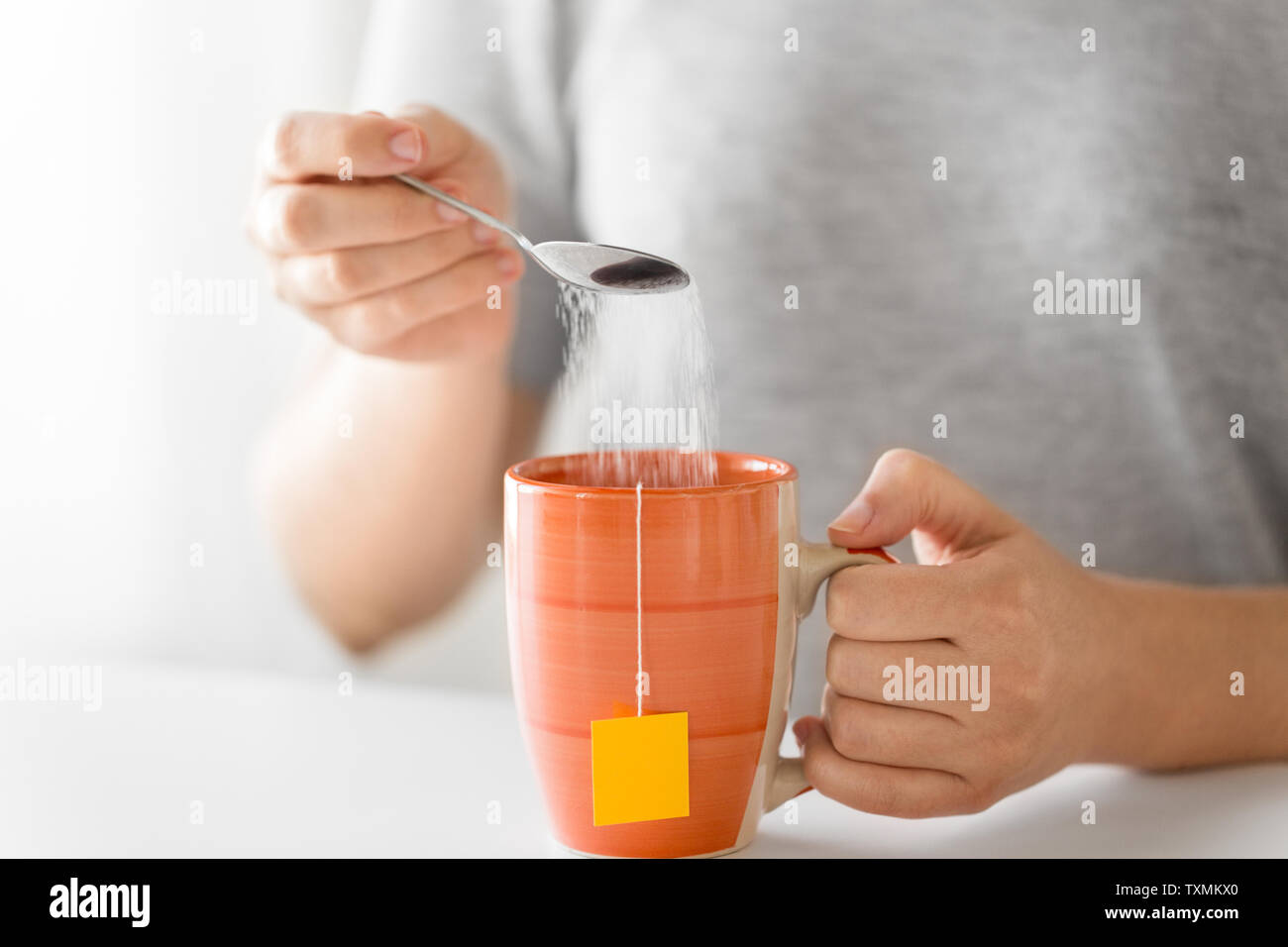 Adding sweetener hi-res stock photography and images - Alamy