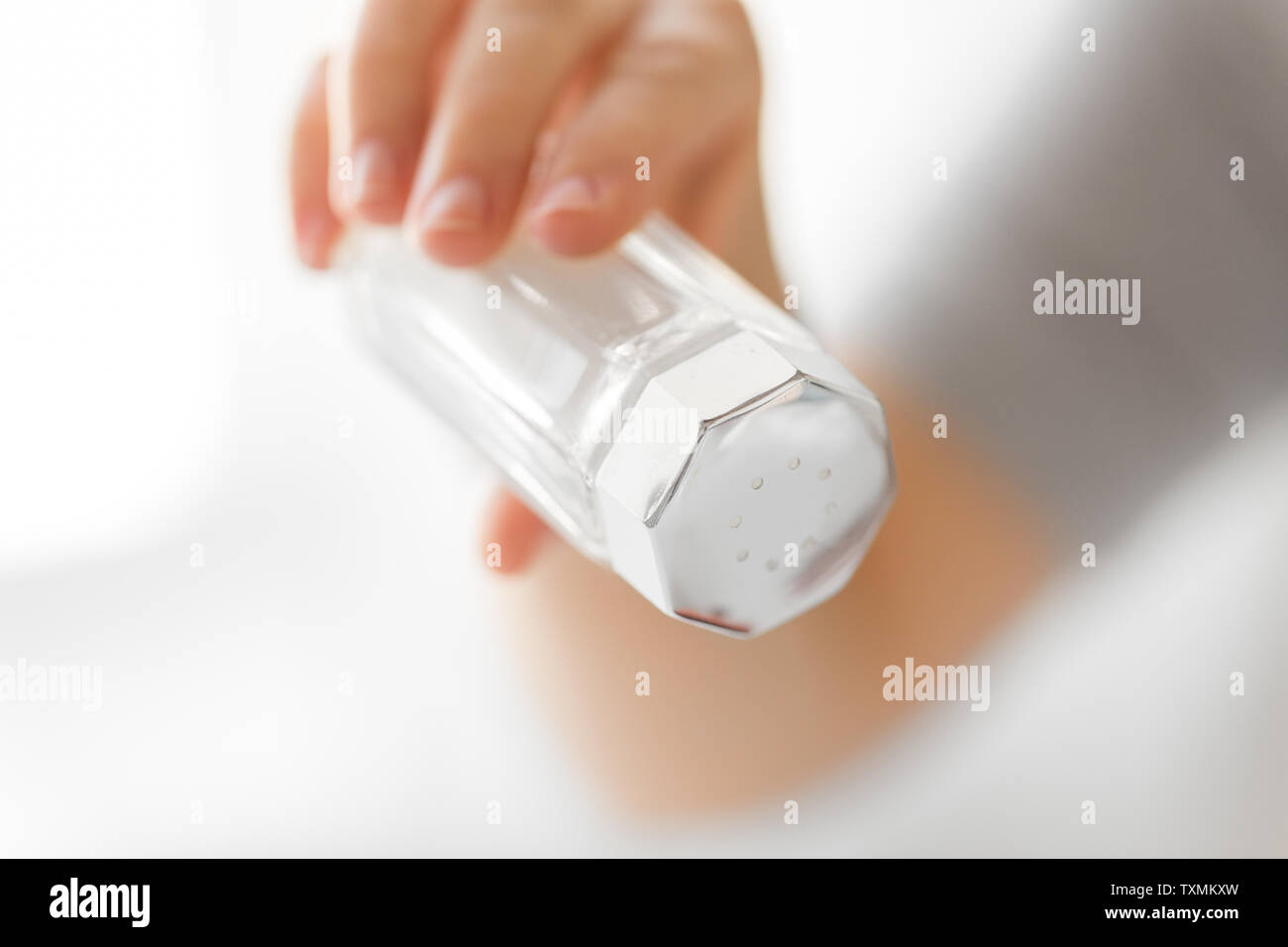 close up of hand holding salt cellar Stock Photo - Alamy
