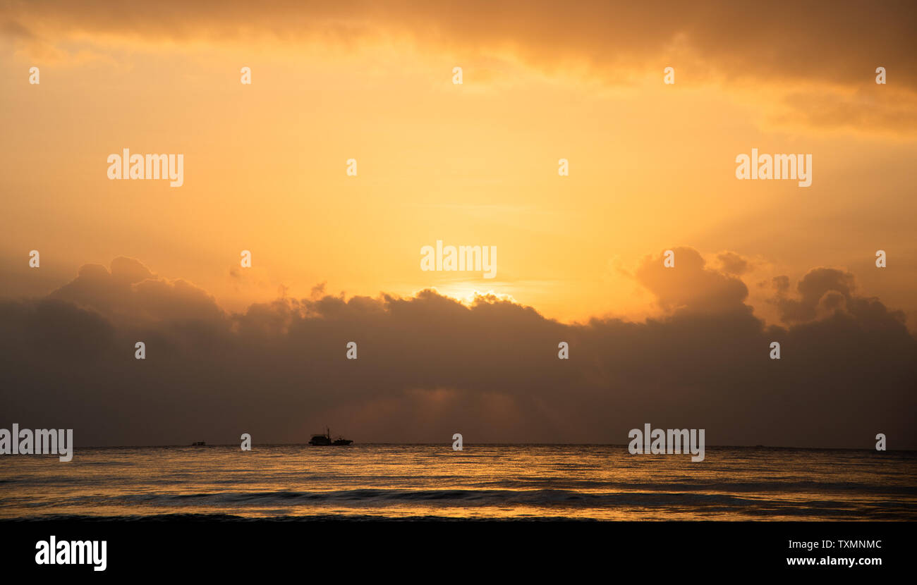 Sunset at sea level Stock Photo - Alamy