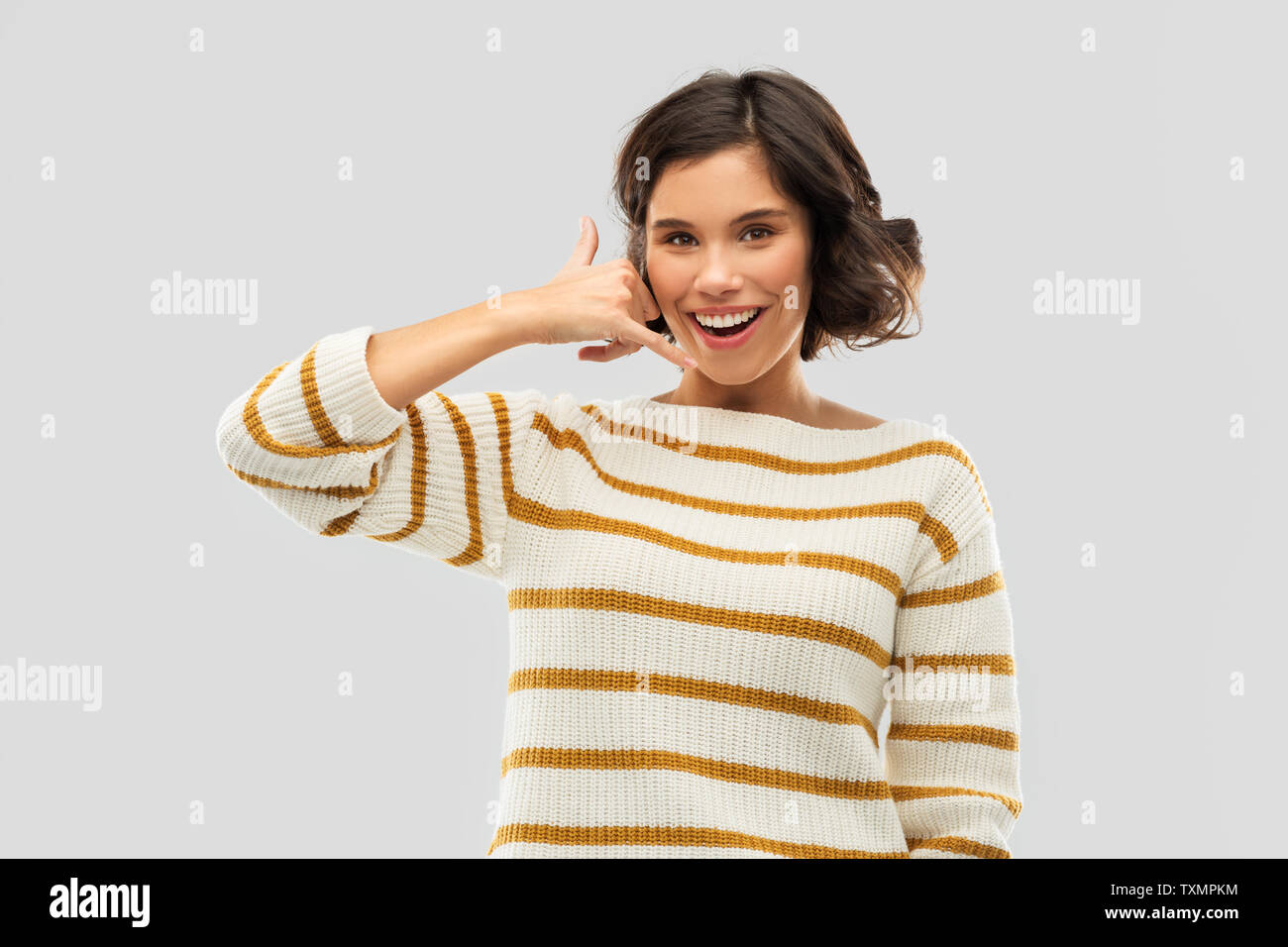 happy smiling woman showing phone call gesture Stock Photo - Alamy