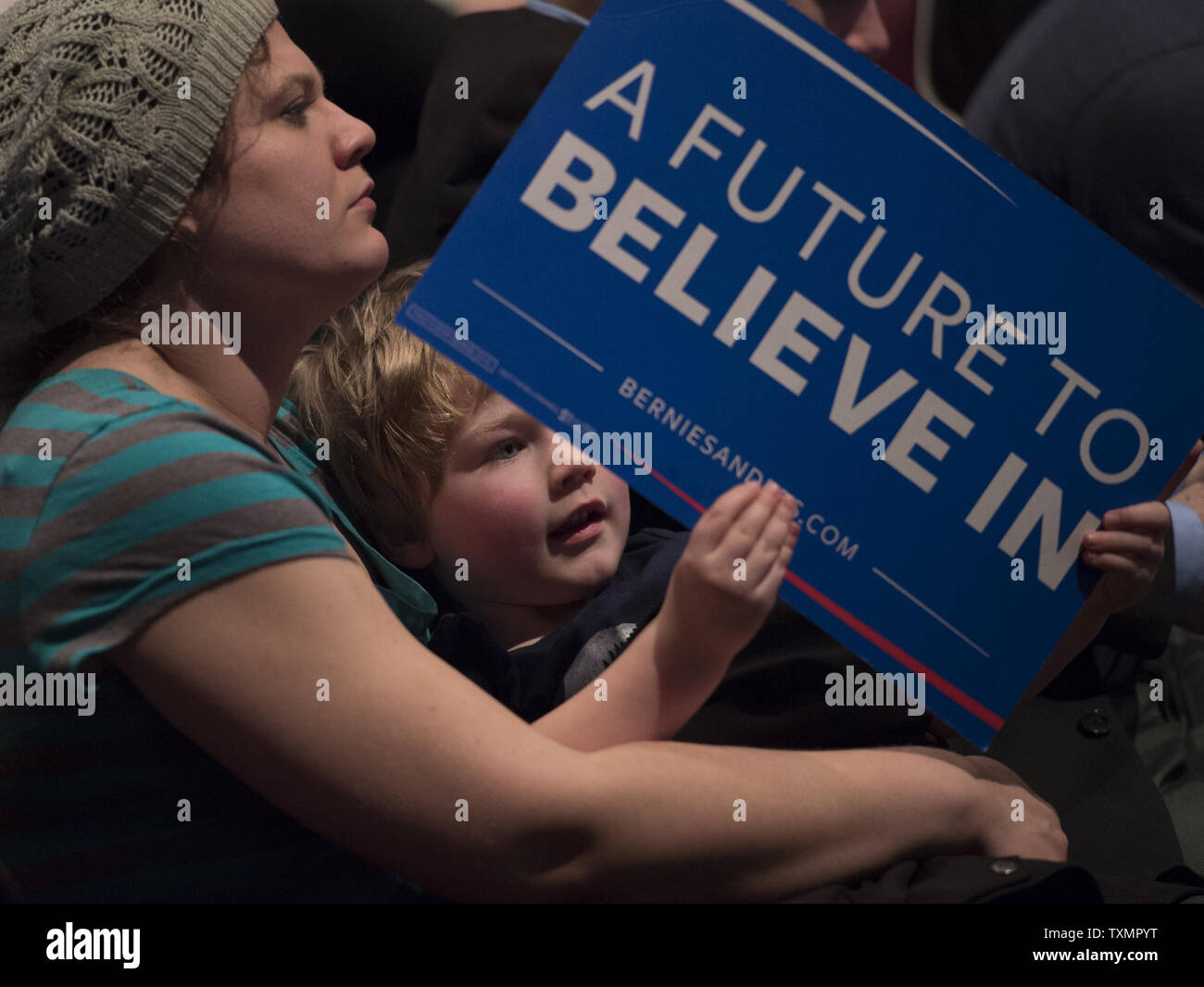 A young child holds a sign in the audience as Democratic presidential ...