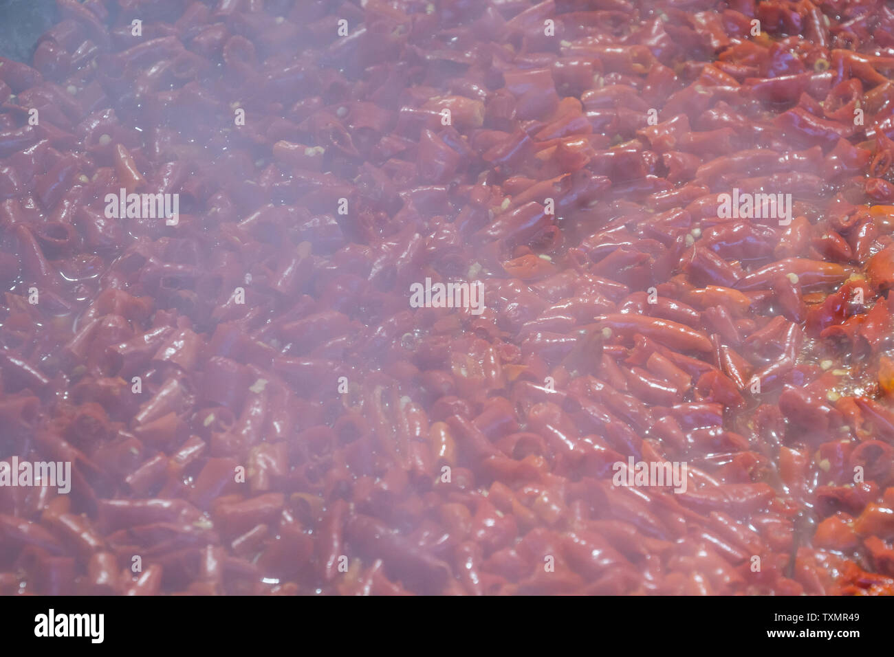 A large pot of fried chili close-up Stock Photo - Alamy