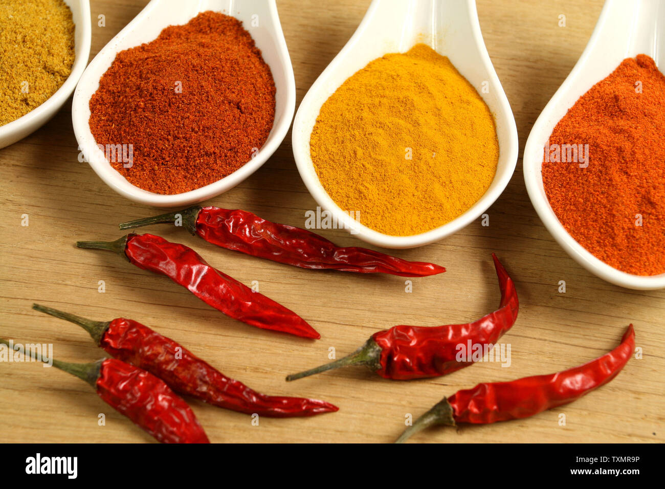 Powder spices in ceramic containers and whole chili peppers Stock Photo ...