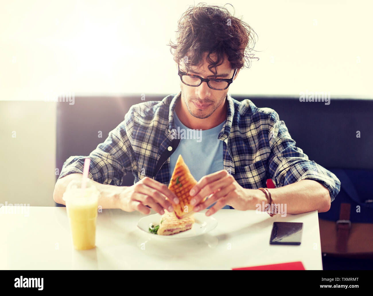 happy man eating sandwich at cafe for lunch Stock Photo - Alamy