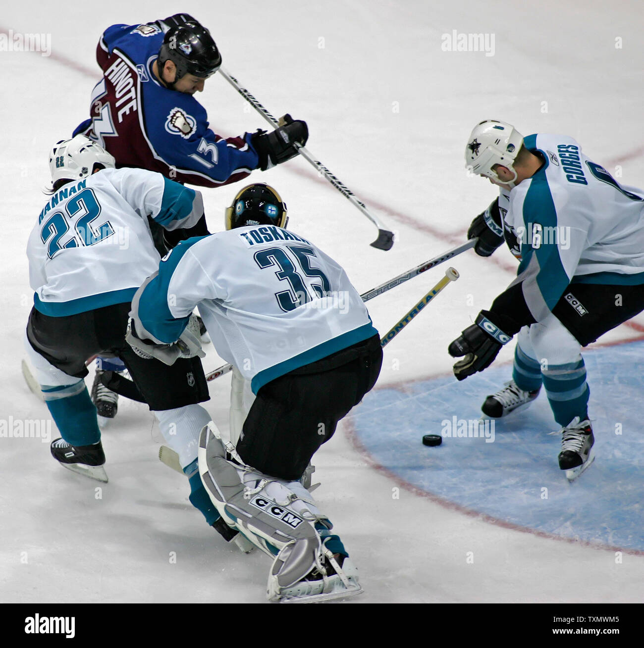 Colorado Avalanche right wing Dan Hinote (top) tries to slap a rebound ...