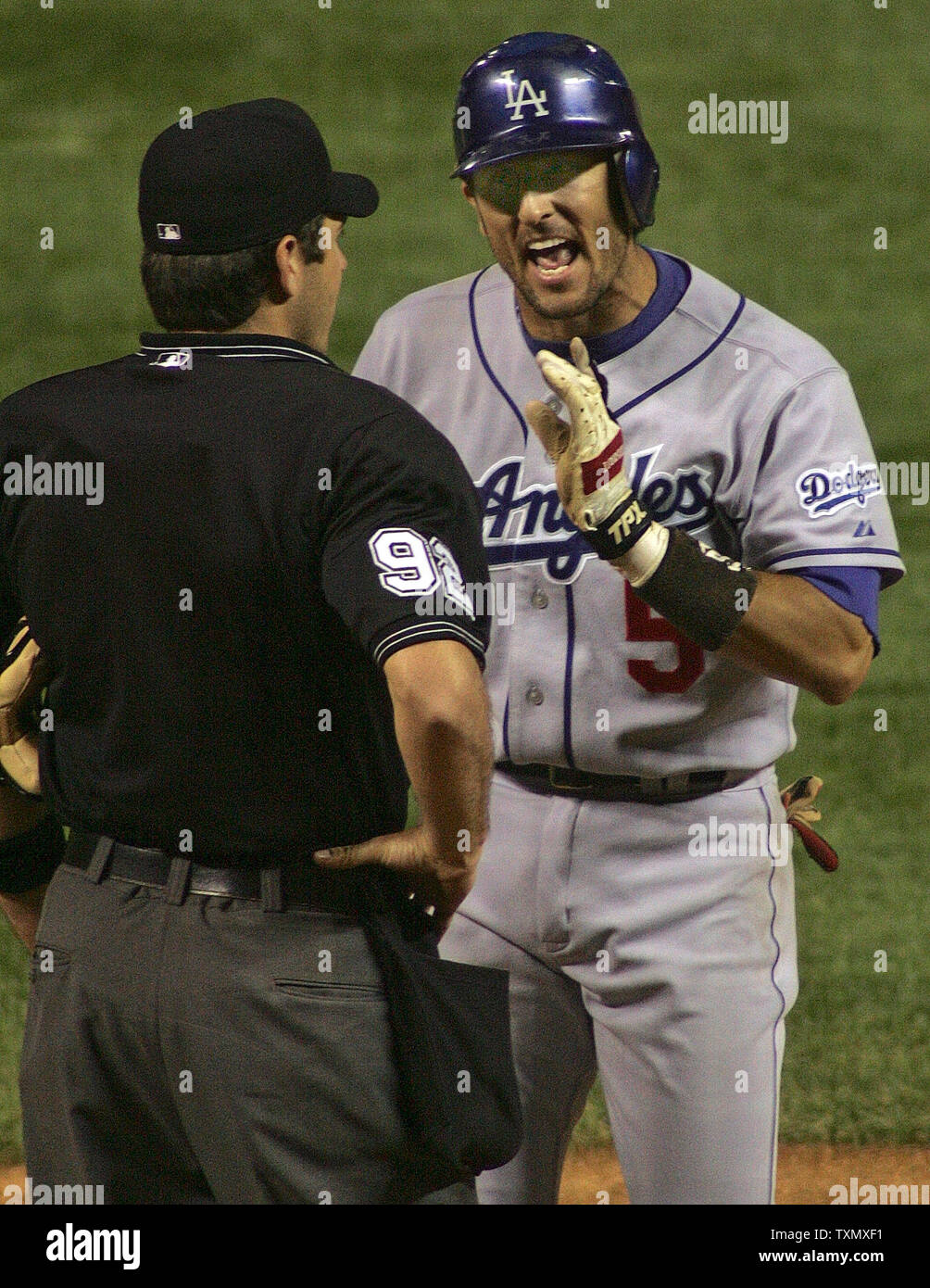 Los Angeles Dodgers batter Nomar Garciaparra (R) argues balls and ...