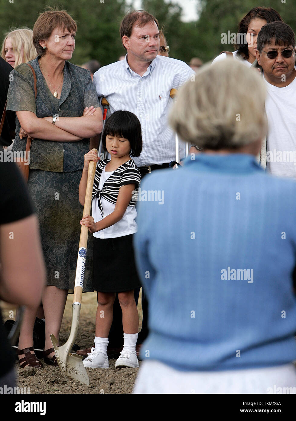Tom Mauser (C) stands next to his adopted daughter Madeline HaiXing ...
