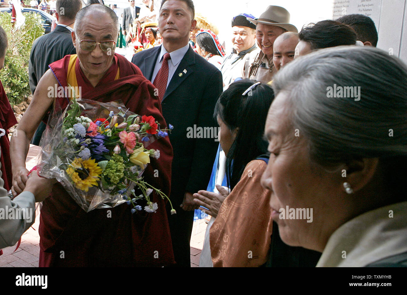 Nobel Peace Laureate The Dalai Lama (L) walks toward his sister Jetsun Pema (R) upon arrival for ...