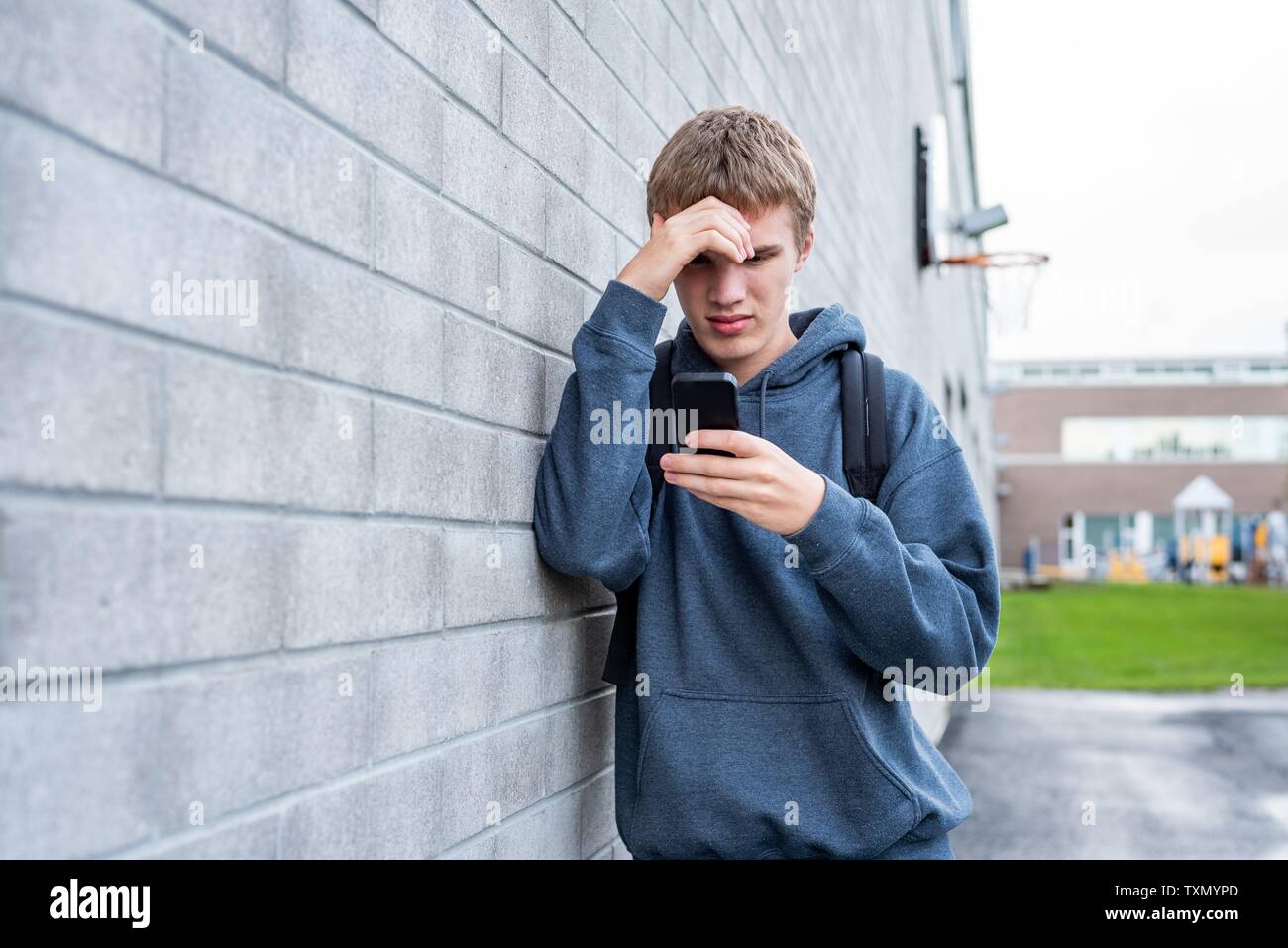 Teenager viewing something upsetting on his cellphone Stock Photo - Alamy