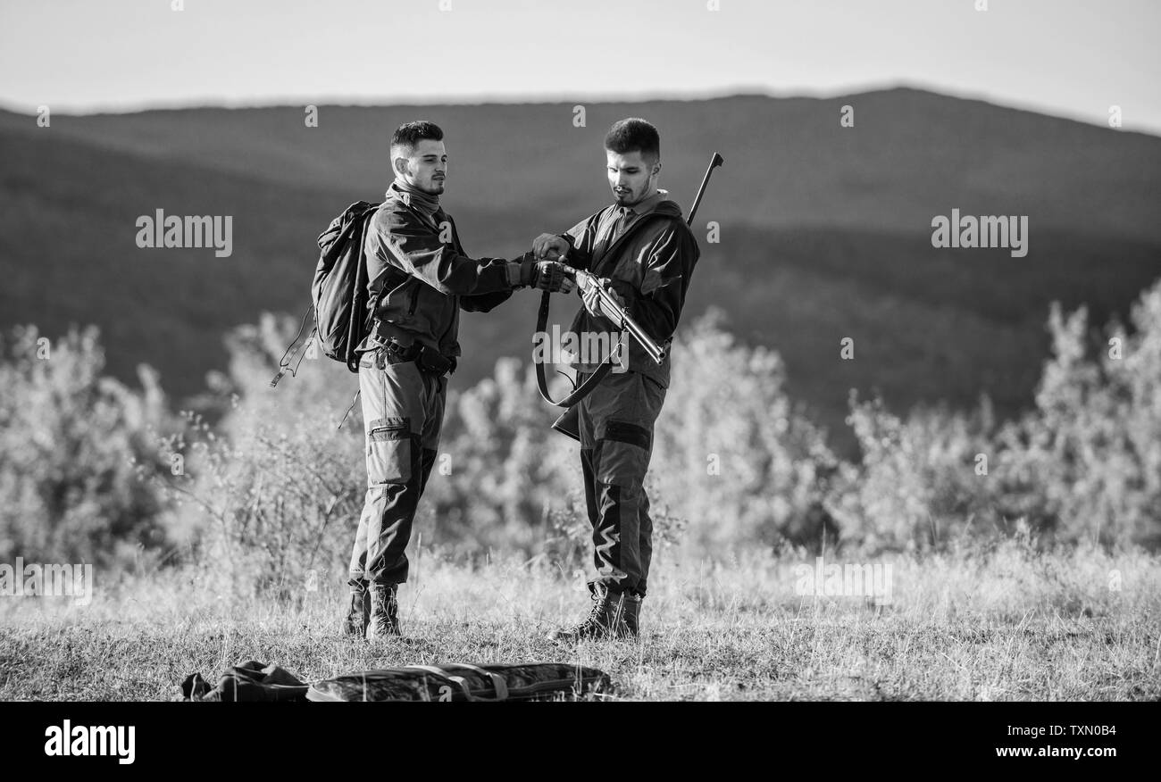 Men bearded hunters with rifle nature background. Experience and ...