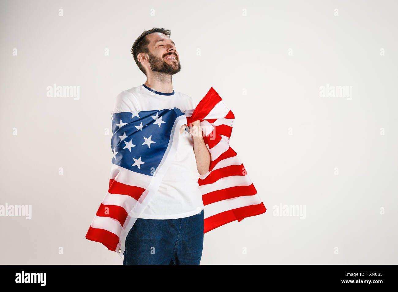 Celebrating an Independence day. Stars and Stripes. Young man with the ...