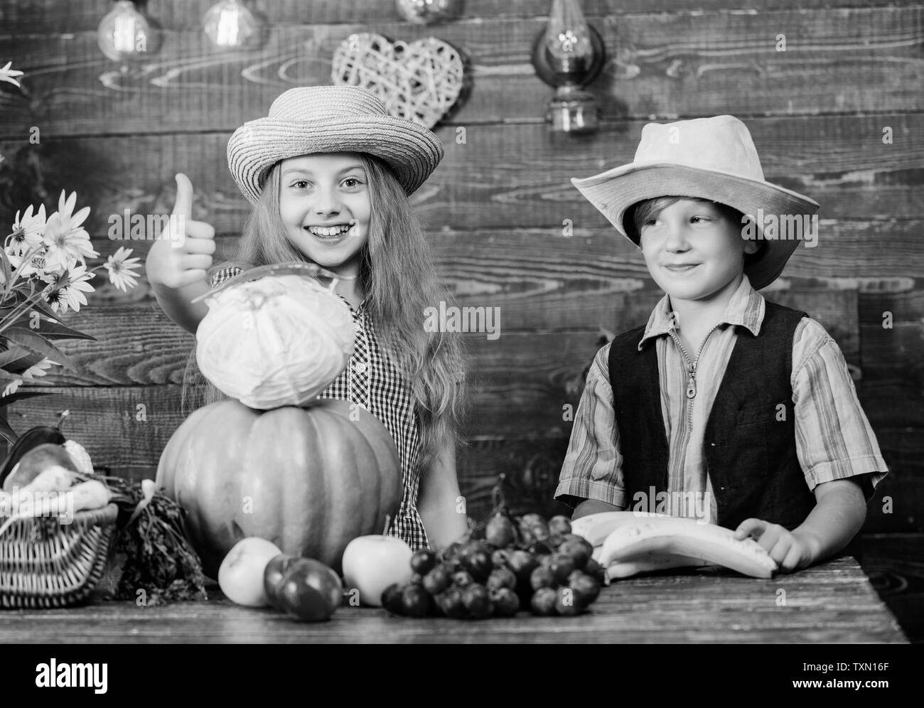Celebrate harvest holiday. Children play vegetables wooden background ...