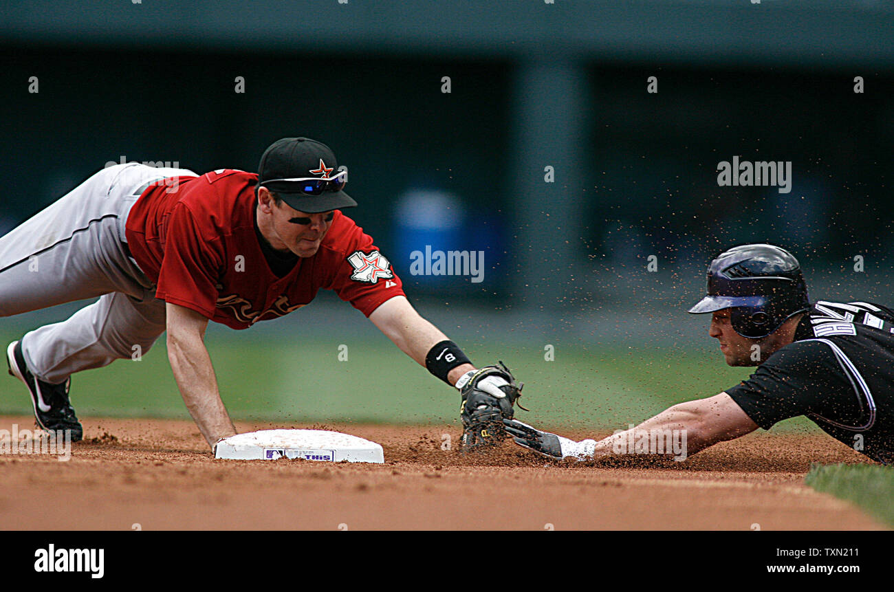 Colorado Rockies runner Matt Holliday (R) slides safely into second ...