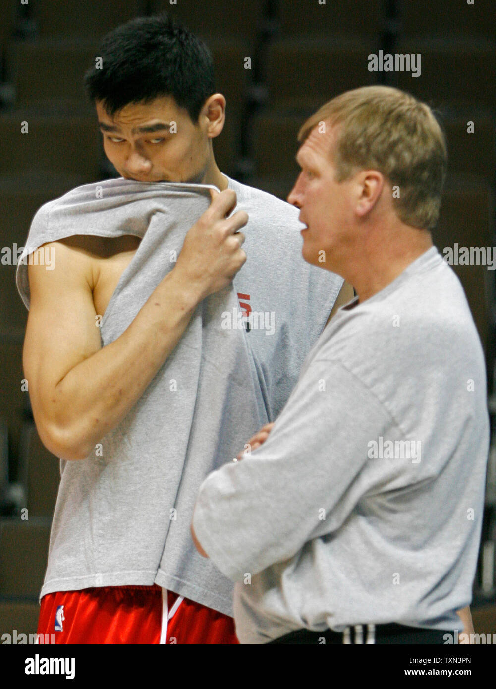 Houston Rockets center Yao Ming (L) of China listens to assistant coach ...