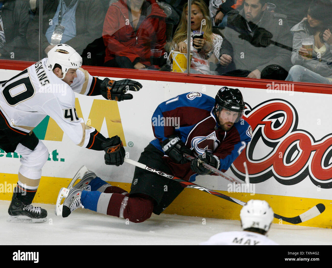 Anaheim Ducks defenseman Kent Huskins (L) takes down Colorado Avalanche ...