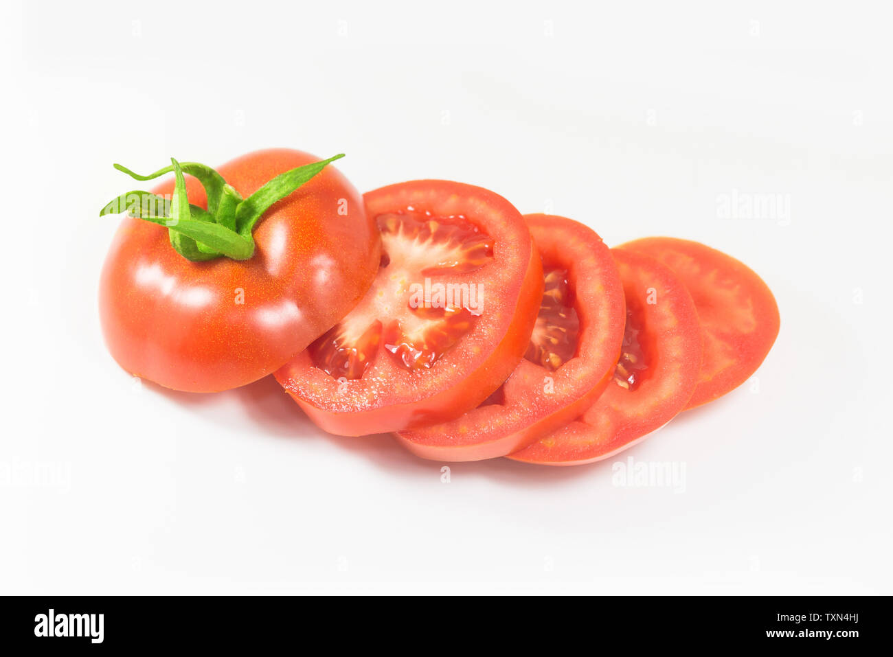 Sliced tomatoes isolated on white background Stock Photo - Alamy