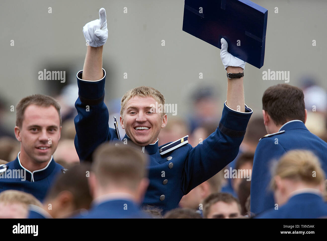 Graduating Air Force cadet celebrates after receiving his diploma at ...