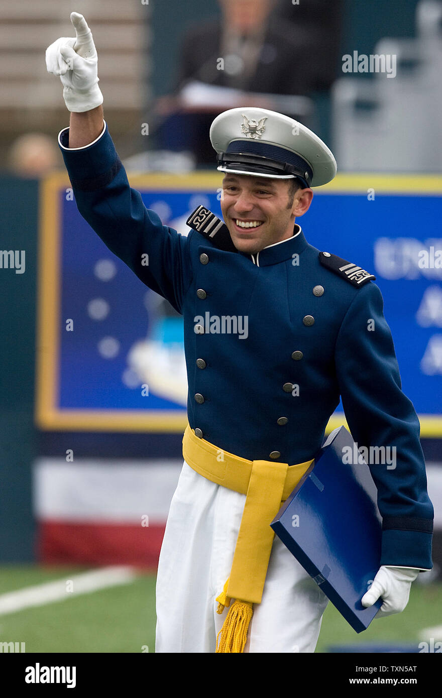 An Air Force graduating senior celebrates after receiving his diploma ...