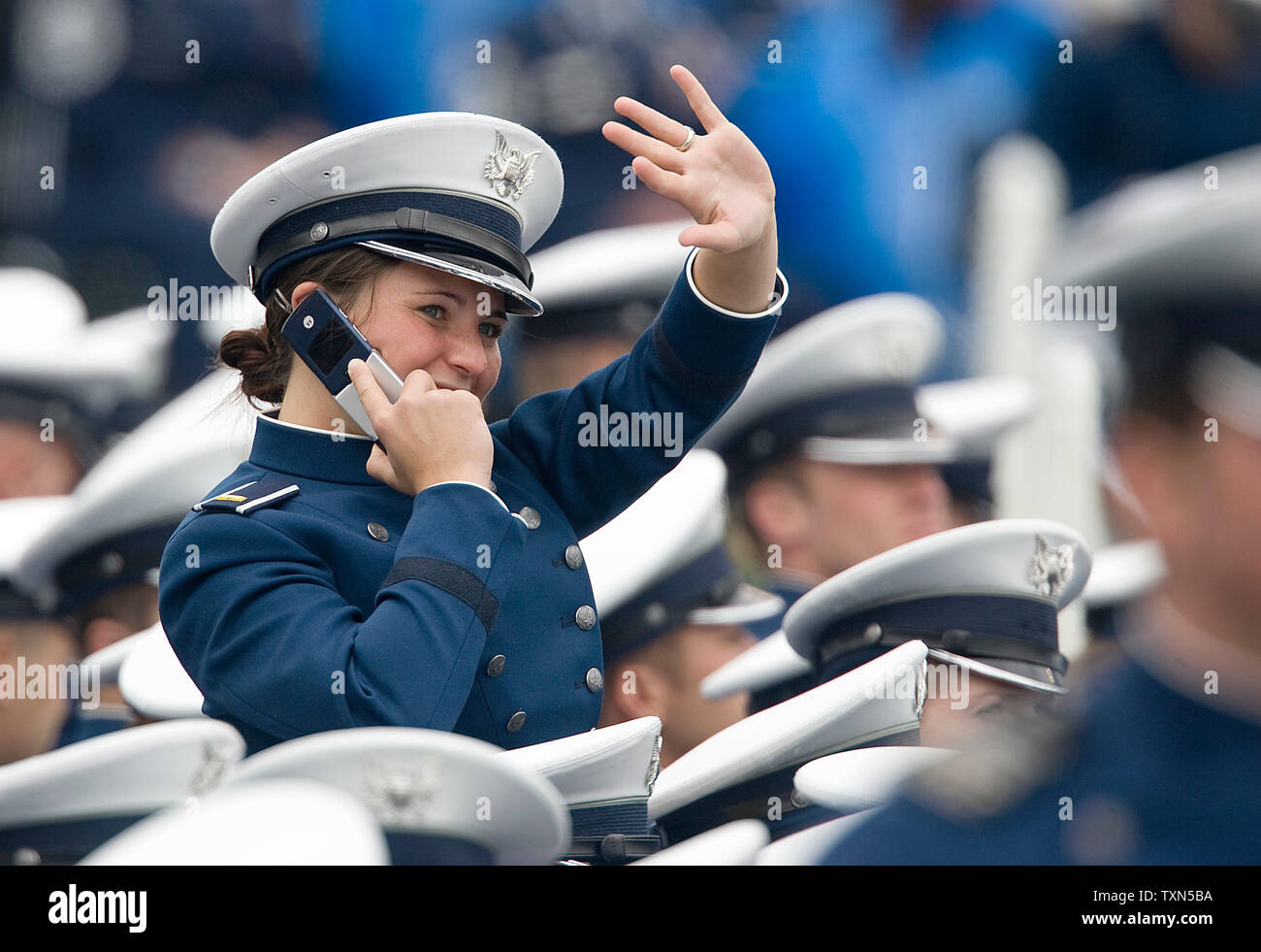 Waving and talking to her family, a newly graduated Air Force cadet ...