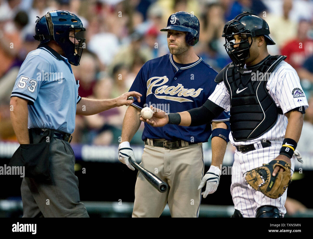 Colorado Rockies catcher Yorvit Torrealba (R) hands the ball to home ...