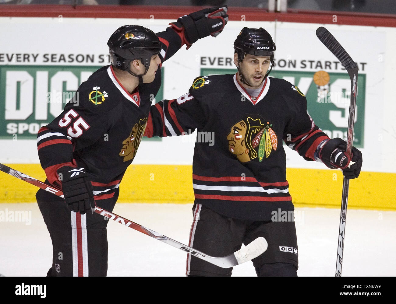 Chicago Blackhawks right wing Craig Adams (R) receives congratulations ...