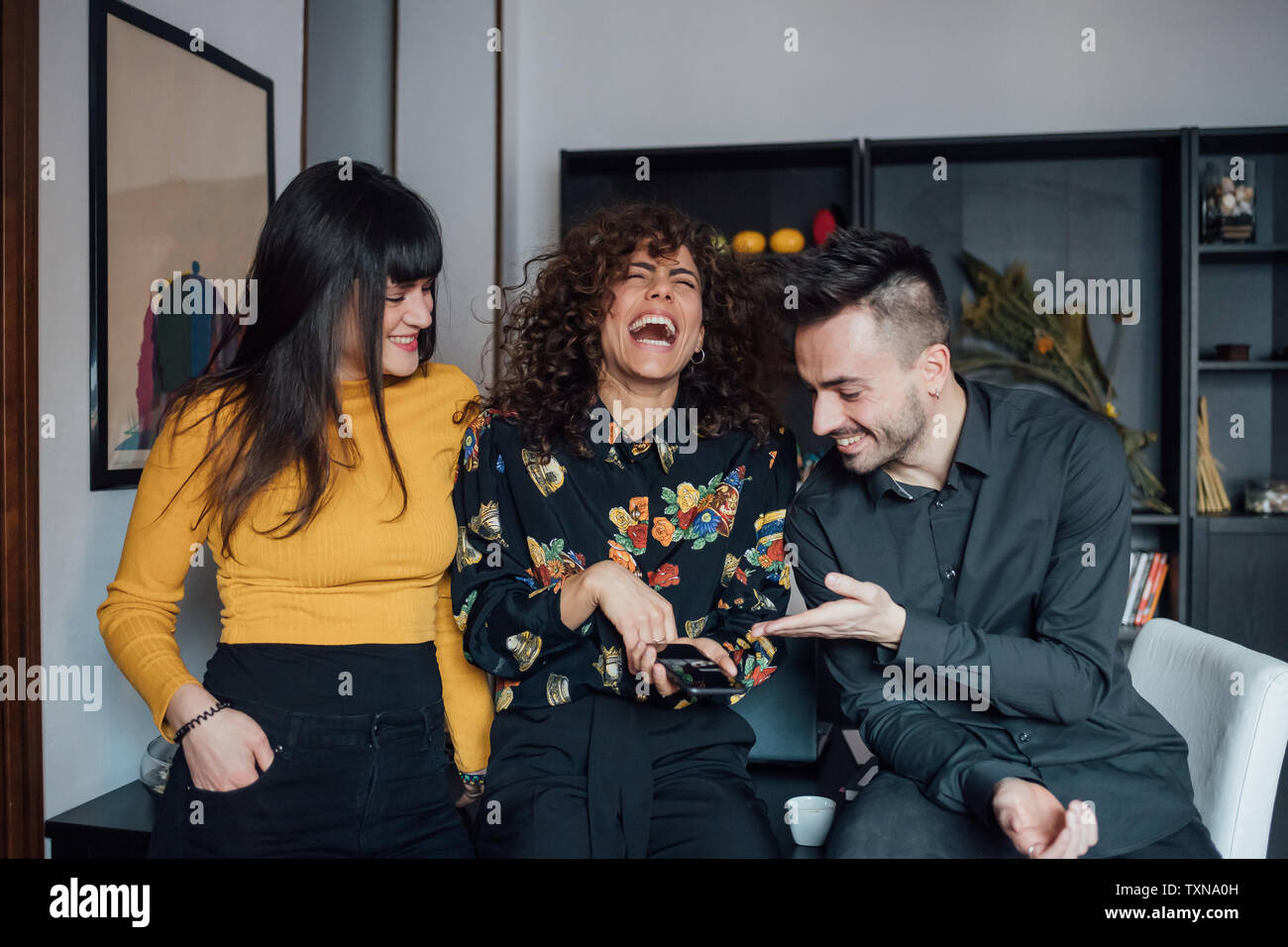 Using smartphone and laughing hi-res stock photography and images - Alamy