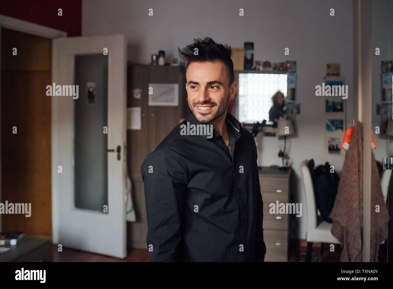 Portrait of young man in room Stock Photo - Alamy