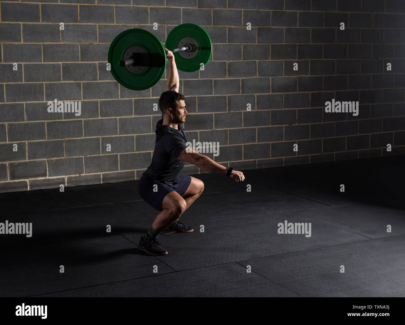 Man training squats in hi-res stock photography and images - Alamy