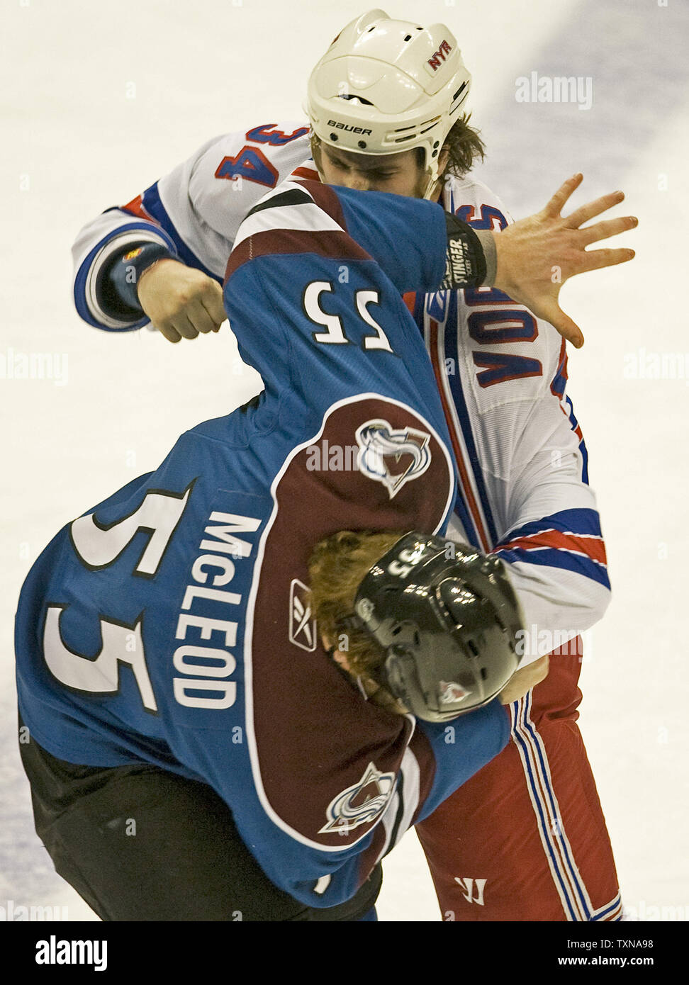 New York Rangers left wing Aaron Voros (top) fights with Colorado ...