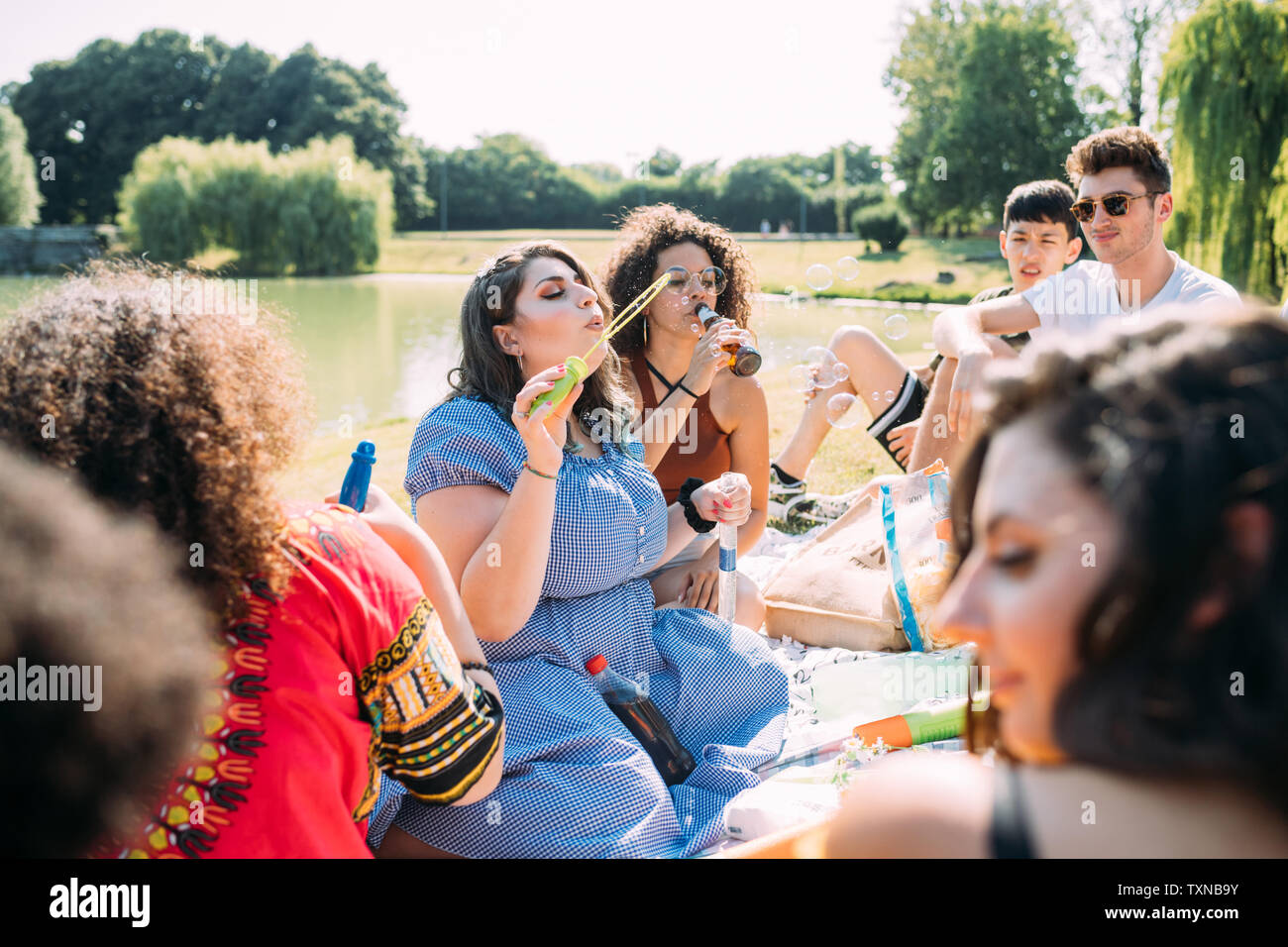 Group of female friends relaxing in park hi-res stock photography and ...