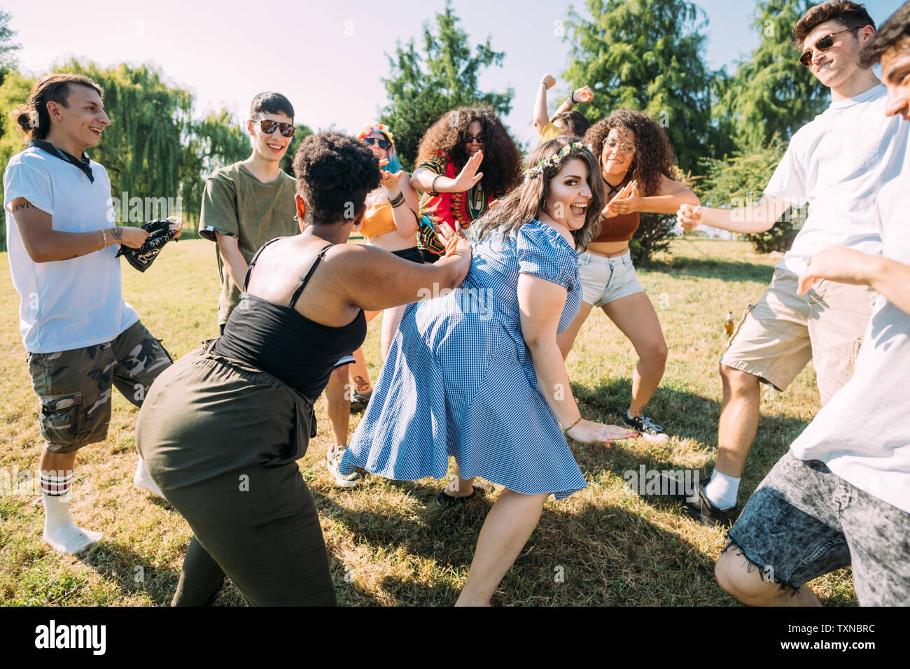 Group of friends dancing in park Stock Photo - Alamy