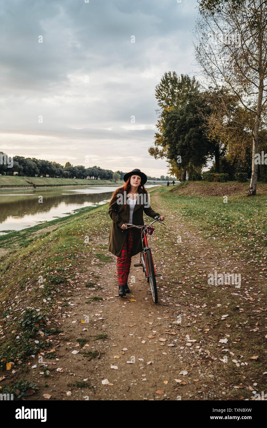 Woman pushing her bicycle hi-res stock photography and images - Alamy