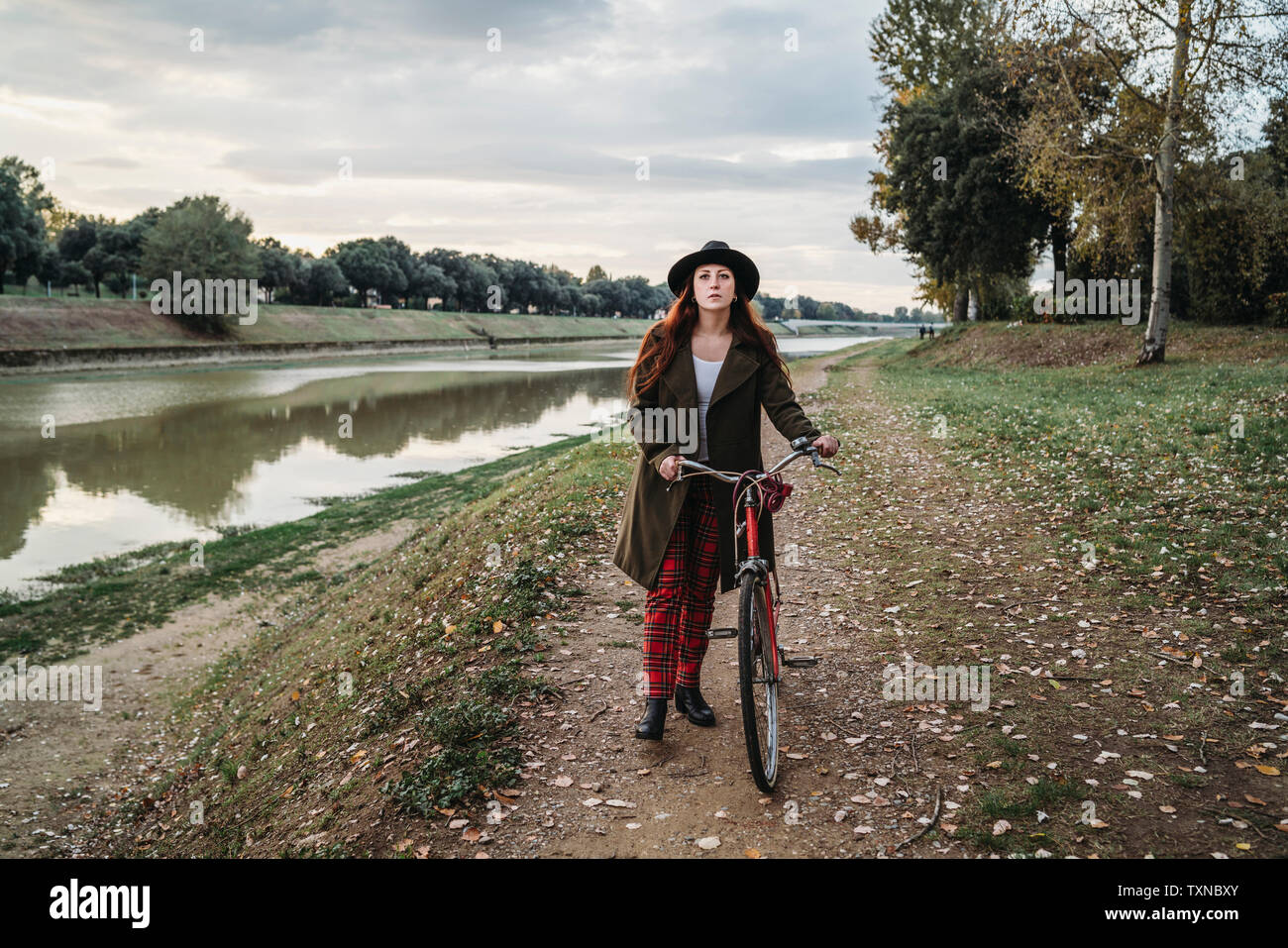 Woman pushing her bicycle hi-res stock photography and images - Alamy
