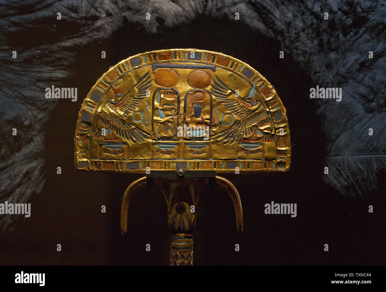 An ornately gold decorated fan is on display at the King Tut traveling ...