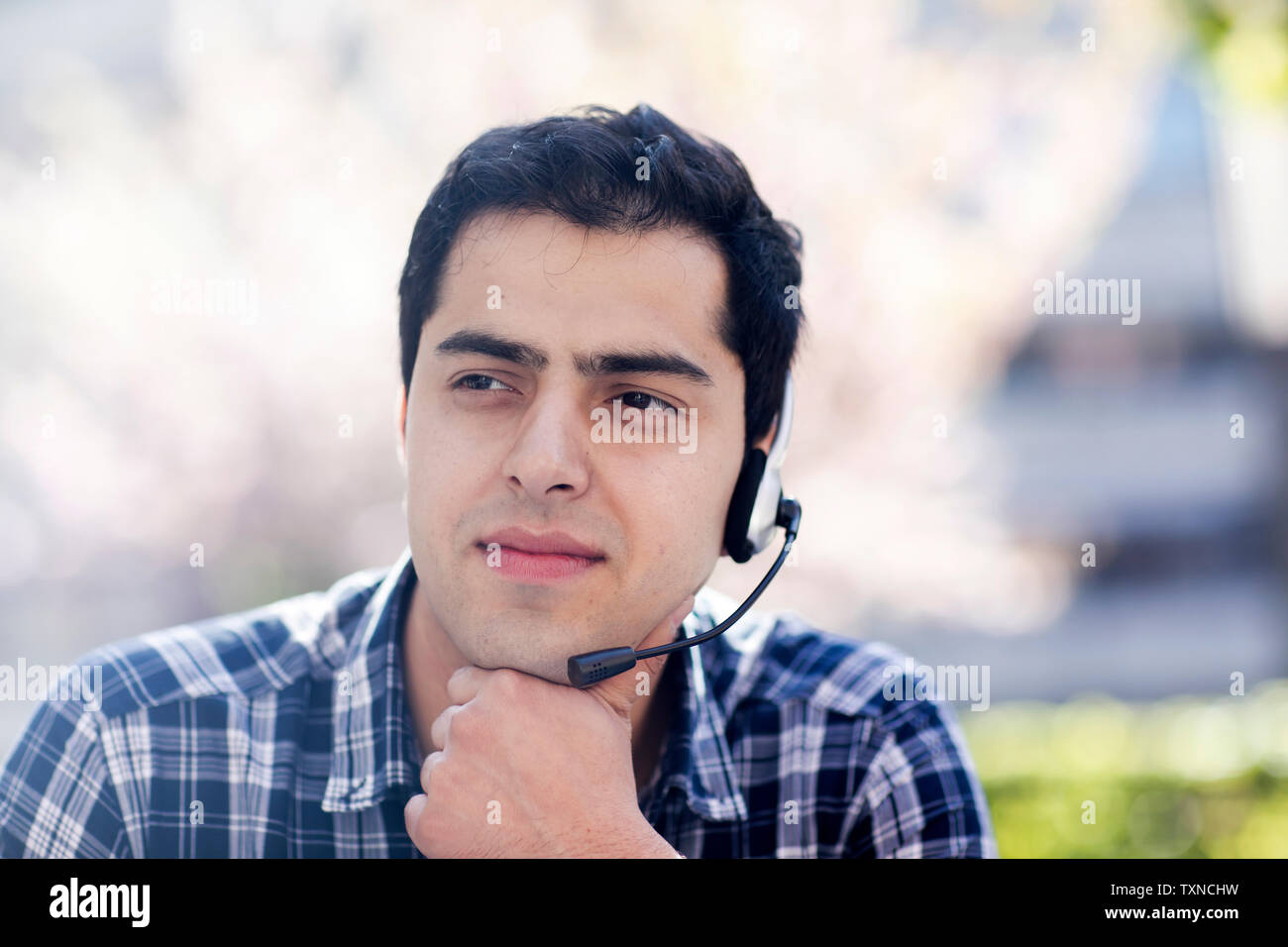 Young man in deep thought outdoors Stock Photo - Alamy