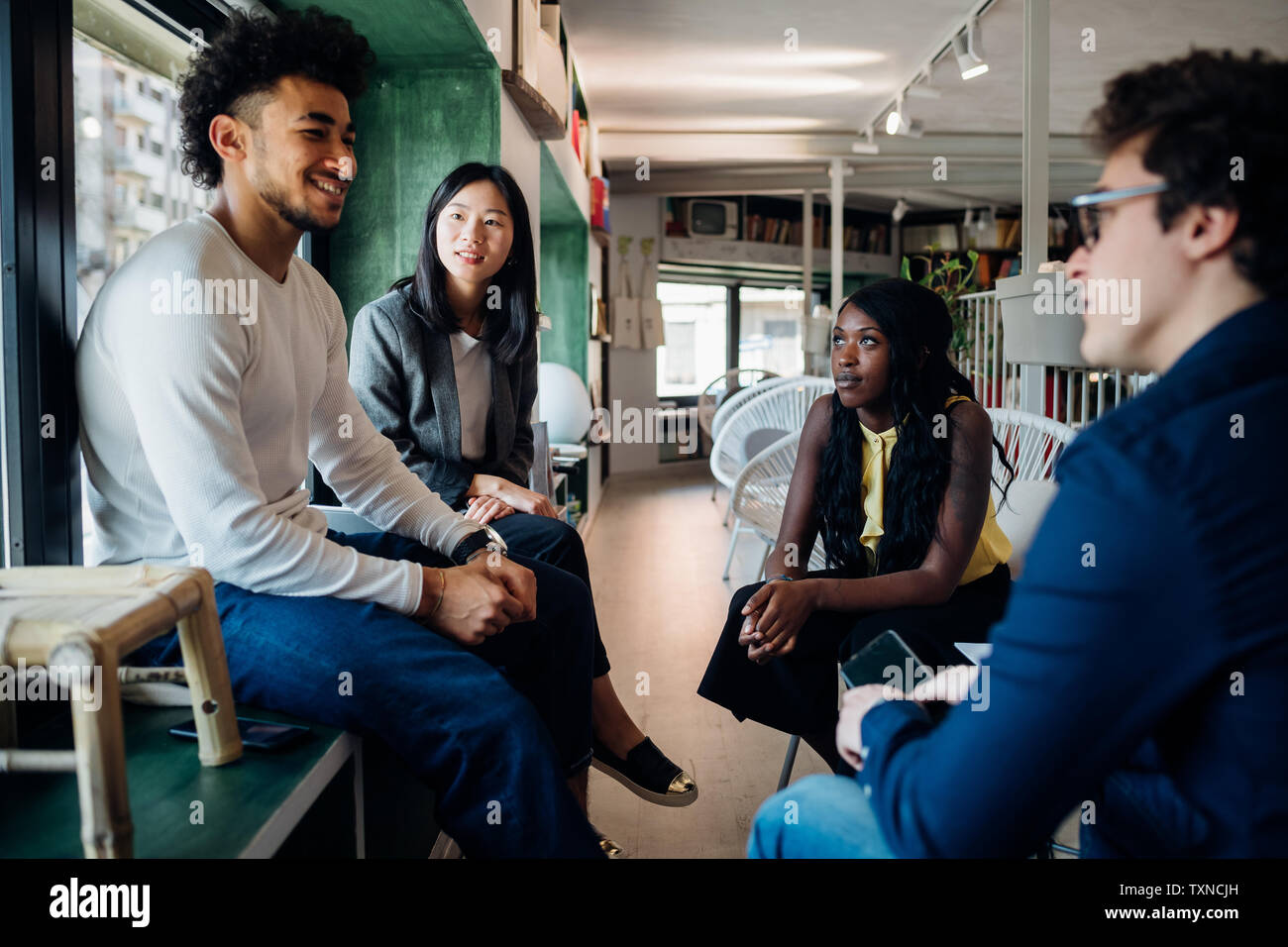 Young male and female business team having informal meeting Stock Photo ...