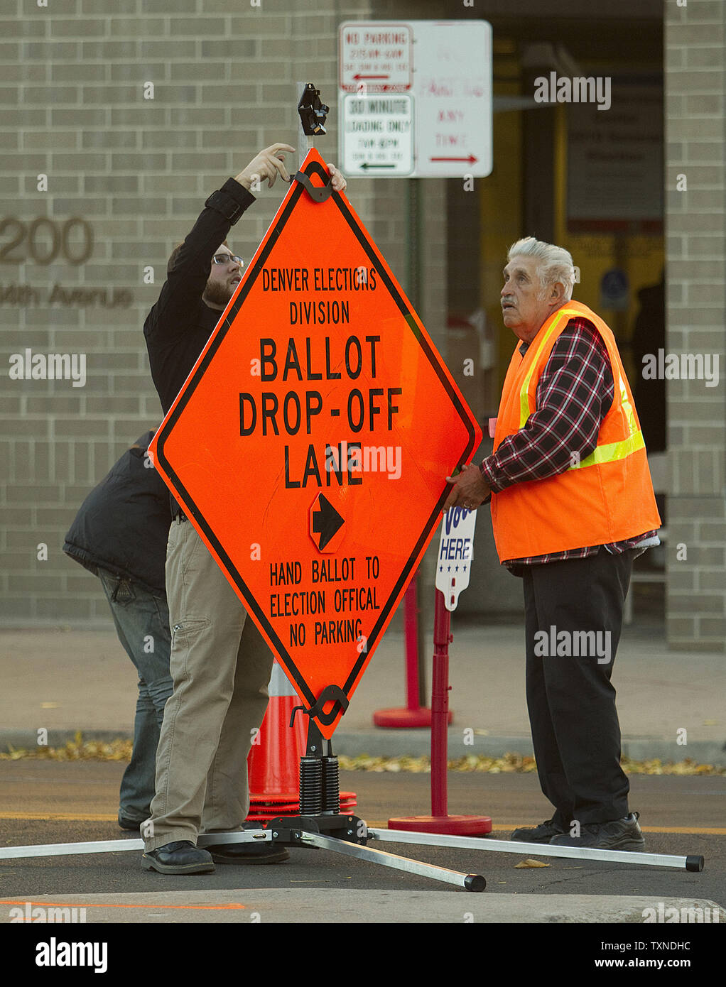 Election workers begin to set up the drive up drop off lane for early ...