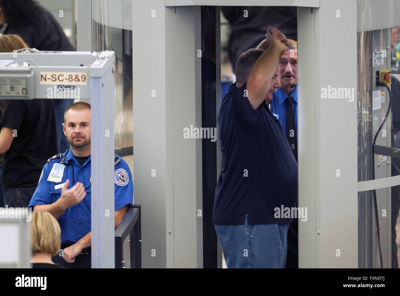 Transportation Security Administration (TSA) agents conduct full-body ...