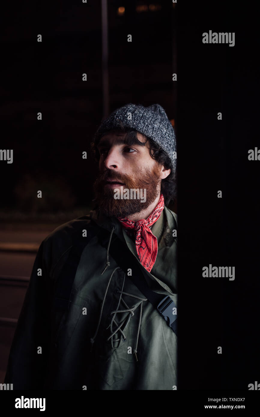Bearded young man loitering on street Stock Photo - Alamy