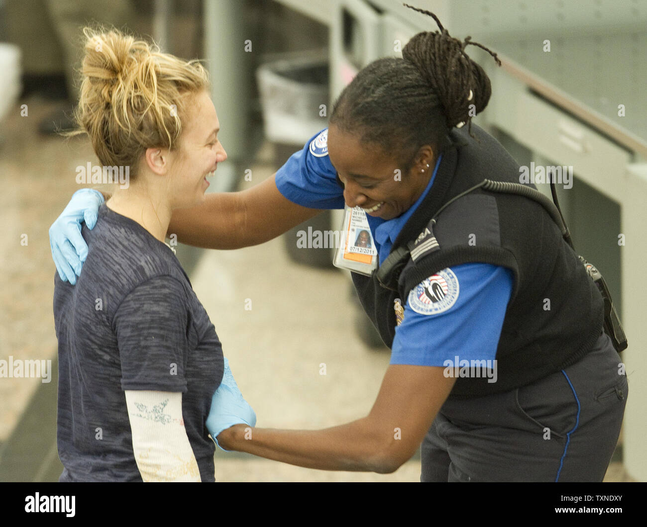 A Transportation Security Administration (TSA) agent maintains a ...